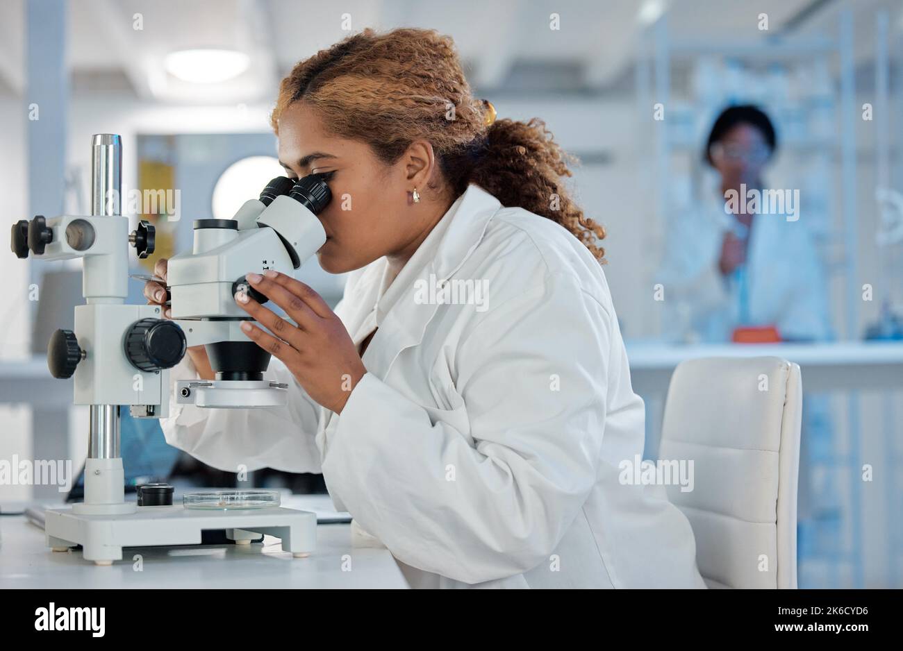 Every slide holds a mystery. a young female lab worker analysing ...