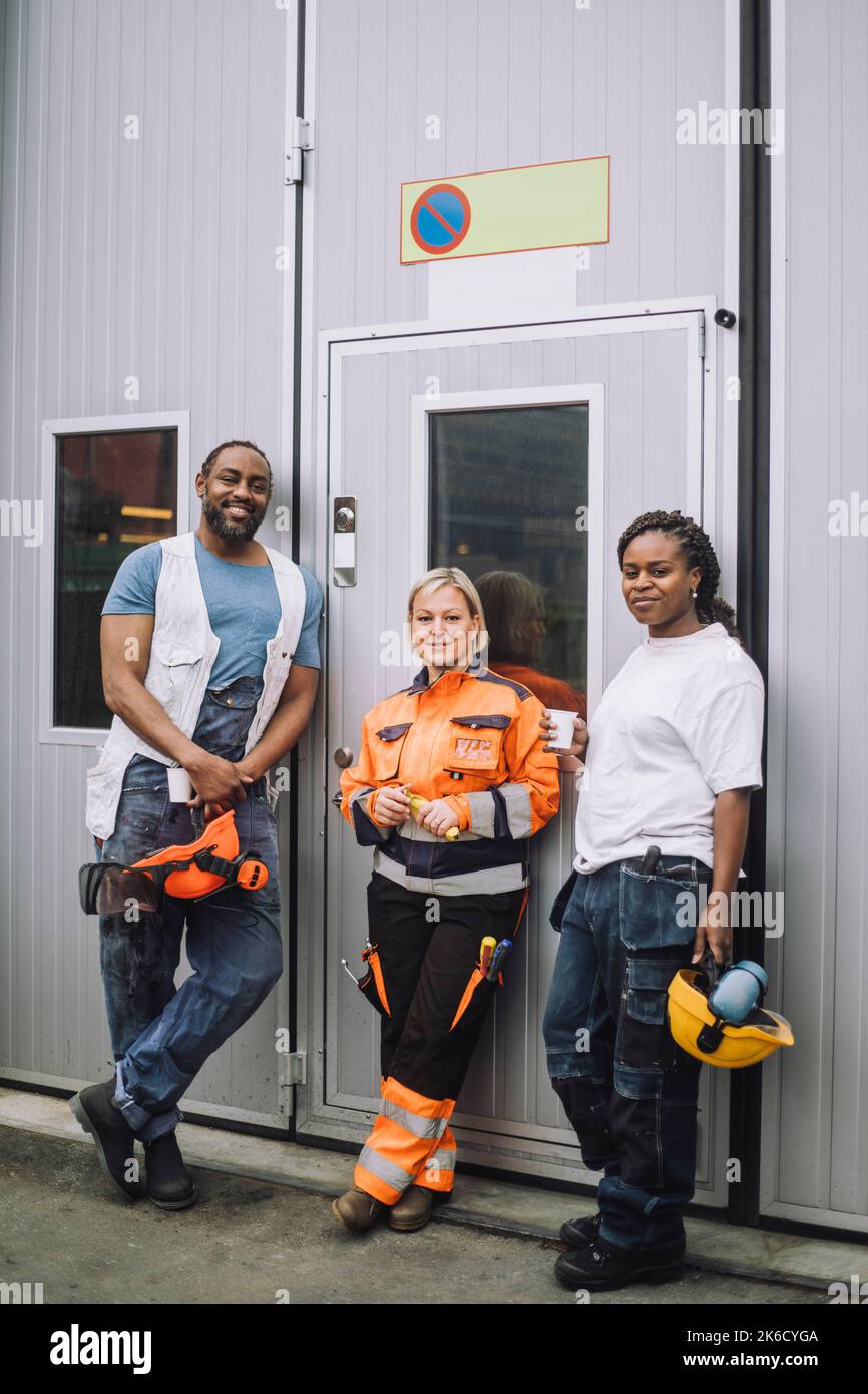 Full length portrait of male and female construction workers at site Stock Photo - Alamy