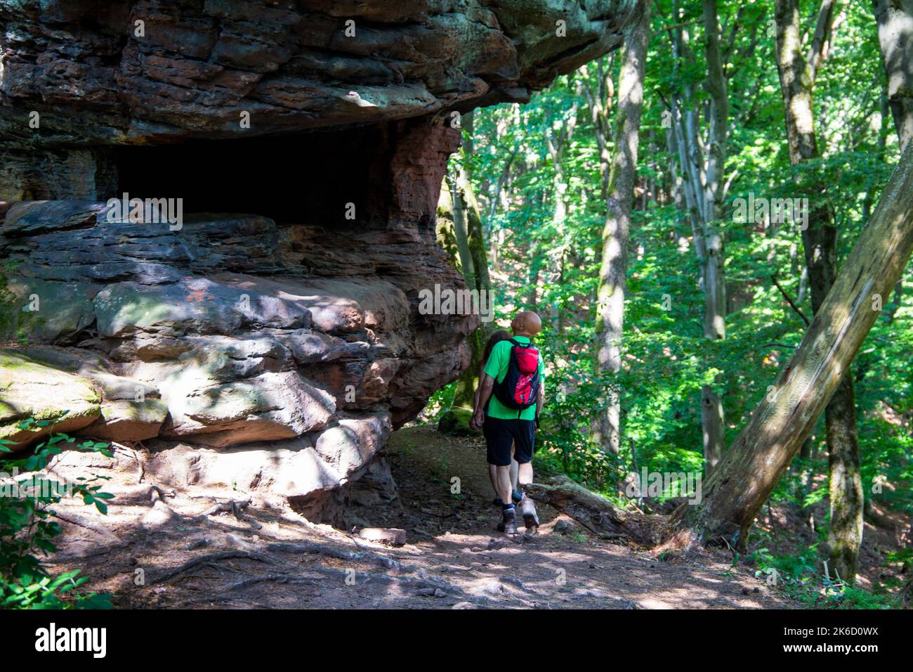 Hikers in the Dahner Felsenland (Germany). The many rock formations of ...