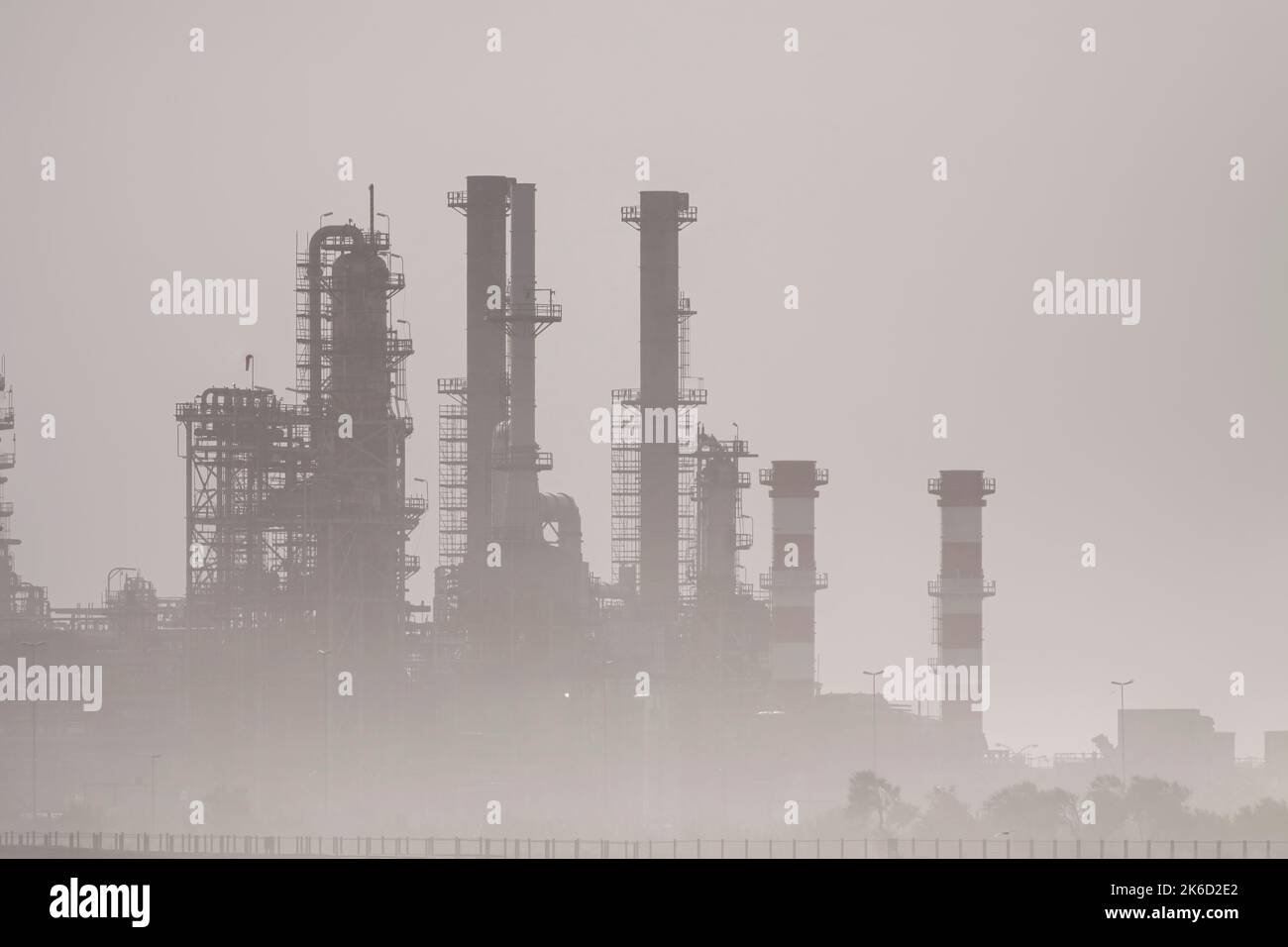 Part of a big oil refinery in the middle of smog and morning mist ...