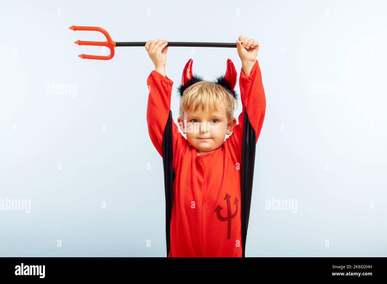 Cute little boy in devil halloween costume with horns and trident Stock ...