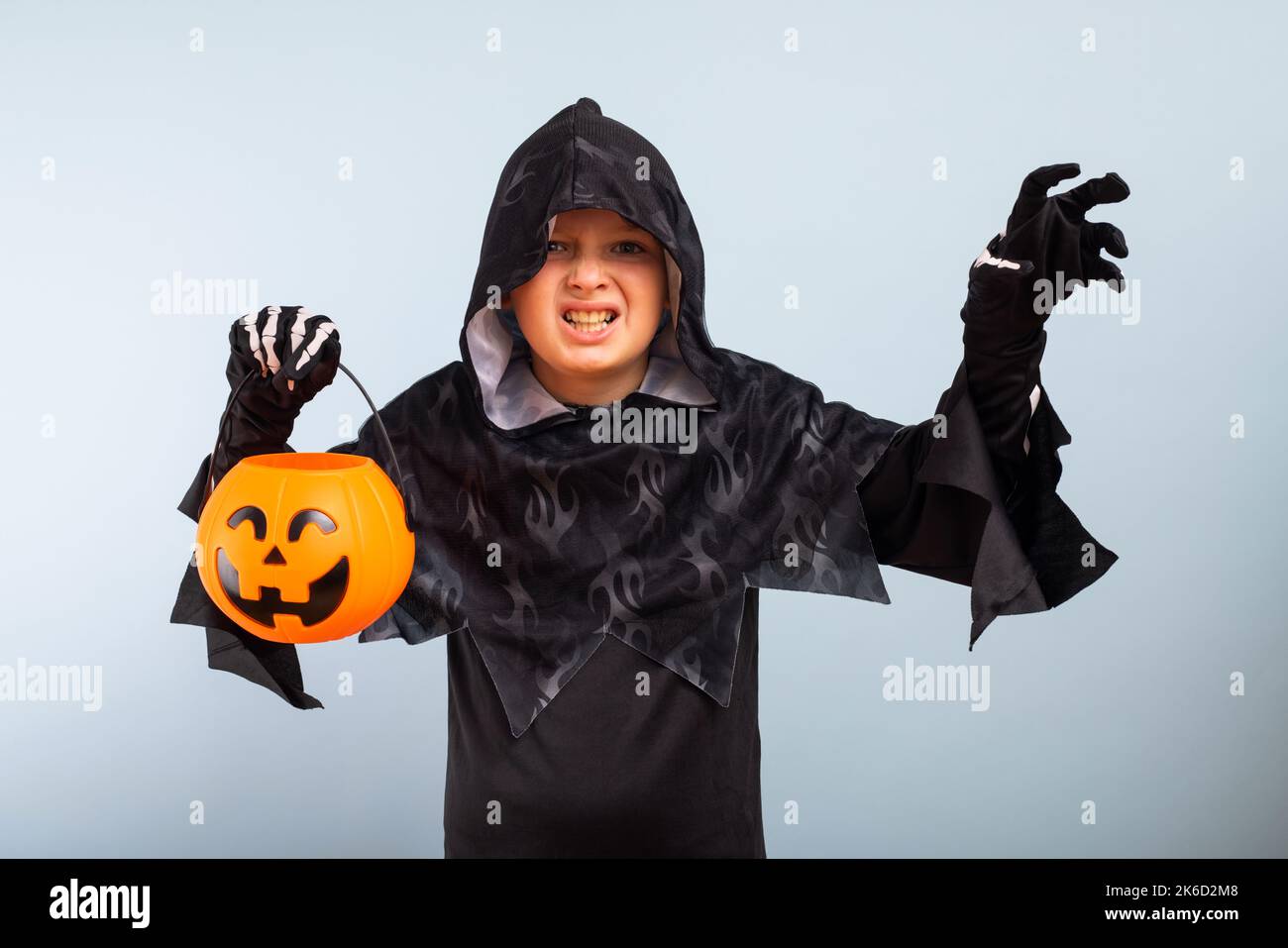 Cute little boy in a costume with a pumpkin basket jack-o-lantern Stock ...