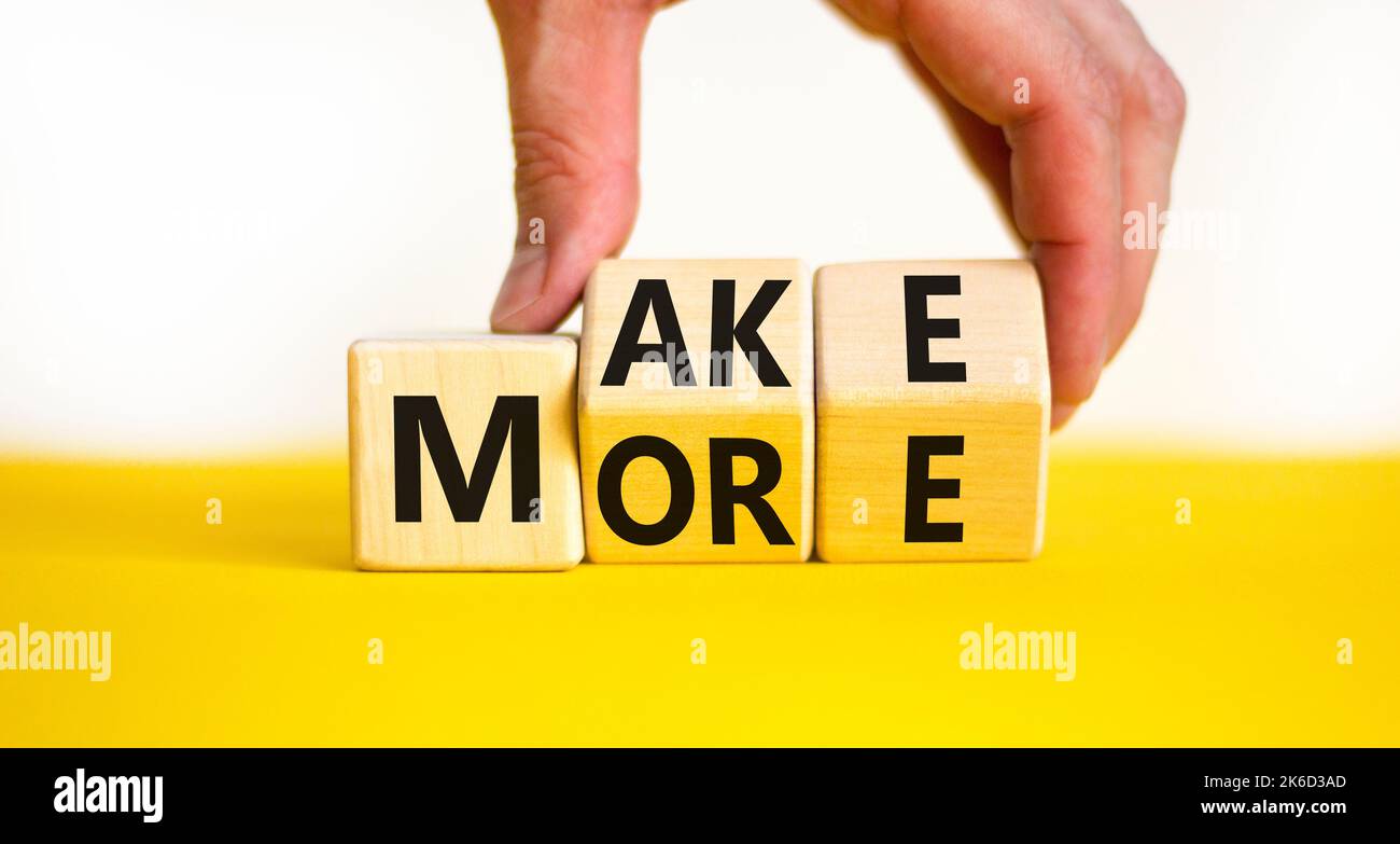 Make more symbol. Concept words Make more on wooden cubes. Businessman ...
