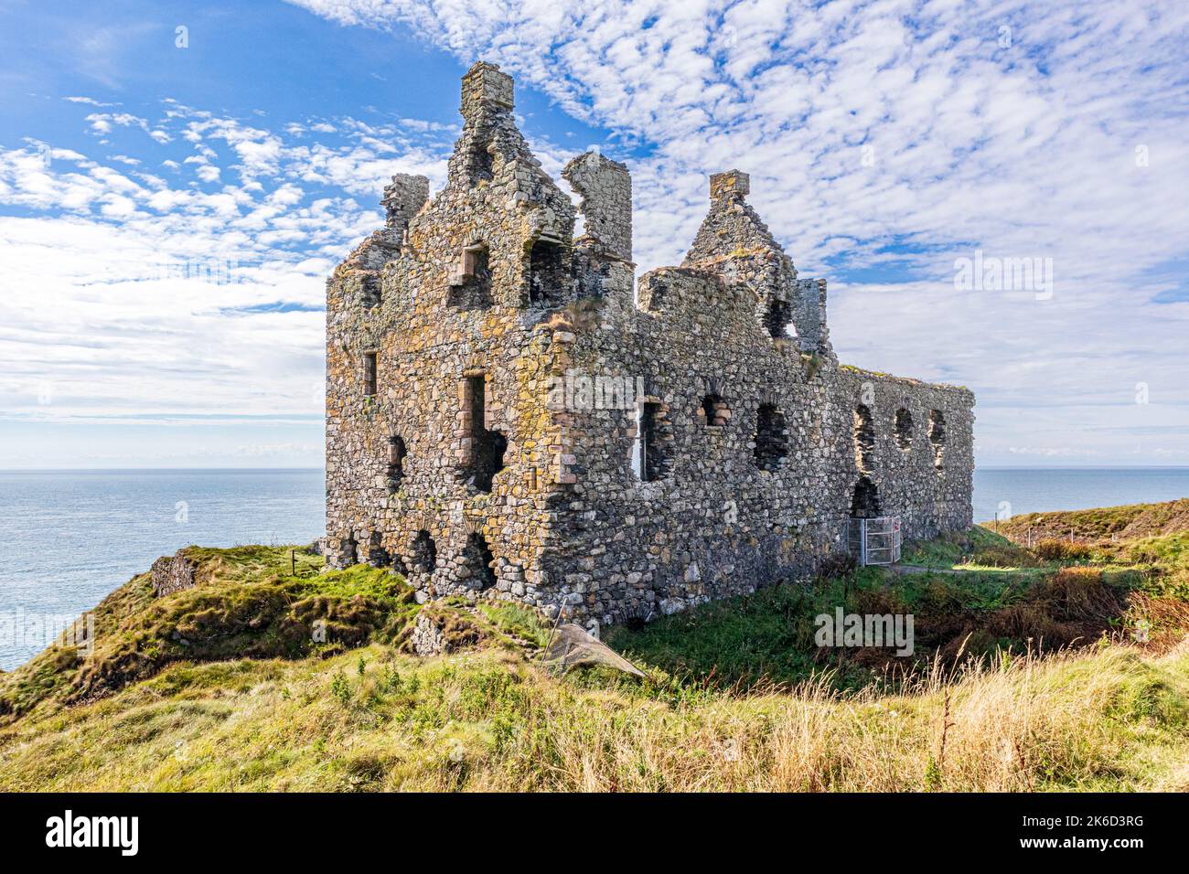 The ruins of 12th century Dunskey Castle on a cliff near the seaside ...