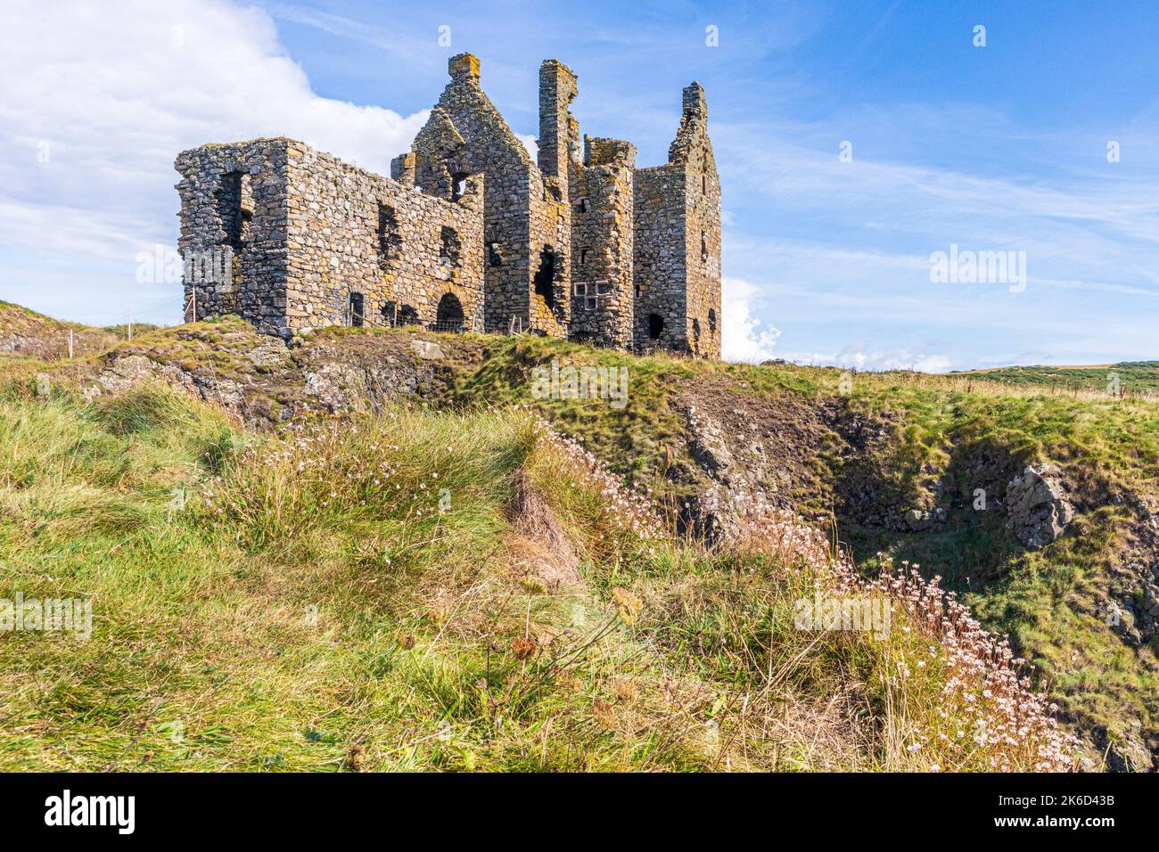 The ruins of 12th century Dunskey Castle on a cliff near the seaside ...