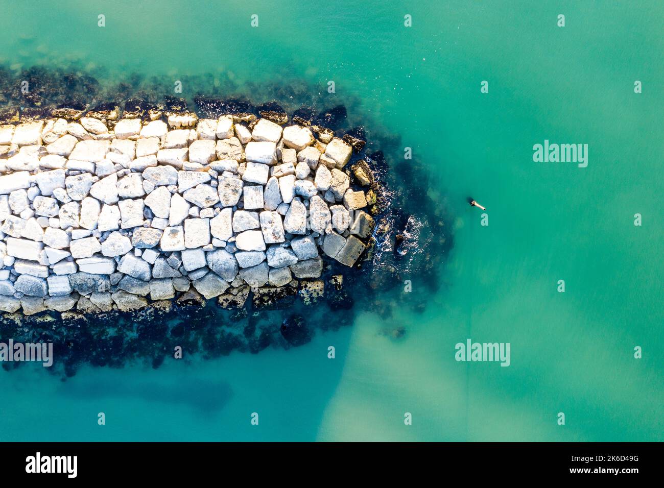 A top view of the green water around a rocky breakwater Stock Photo - Alamy