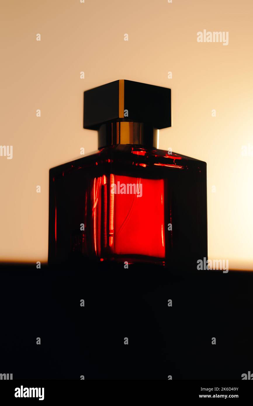 A vertical shot of a backlighted perfume bottle Stock Photo - Alamy