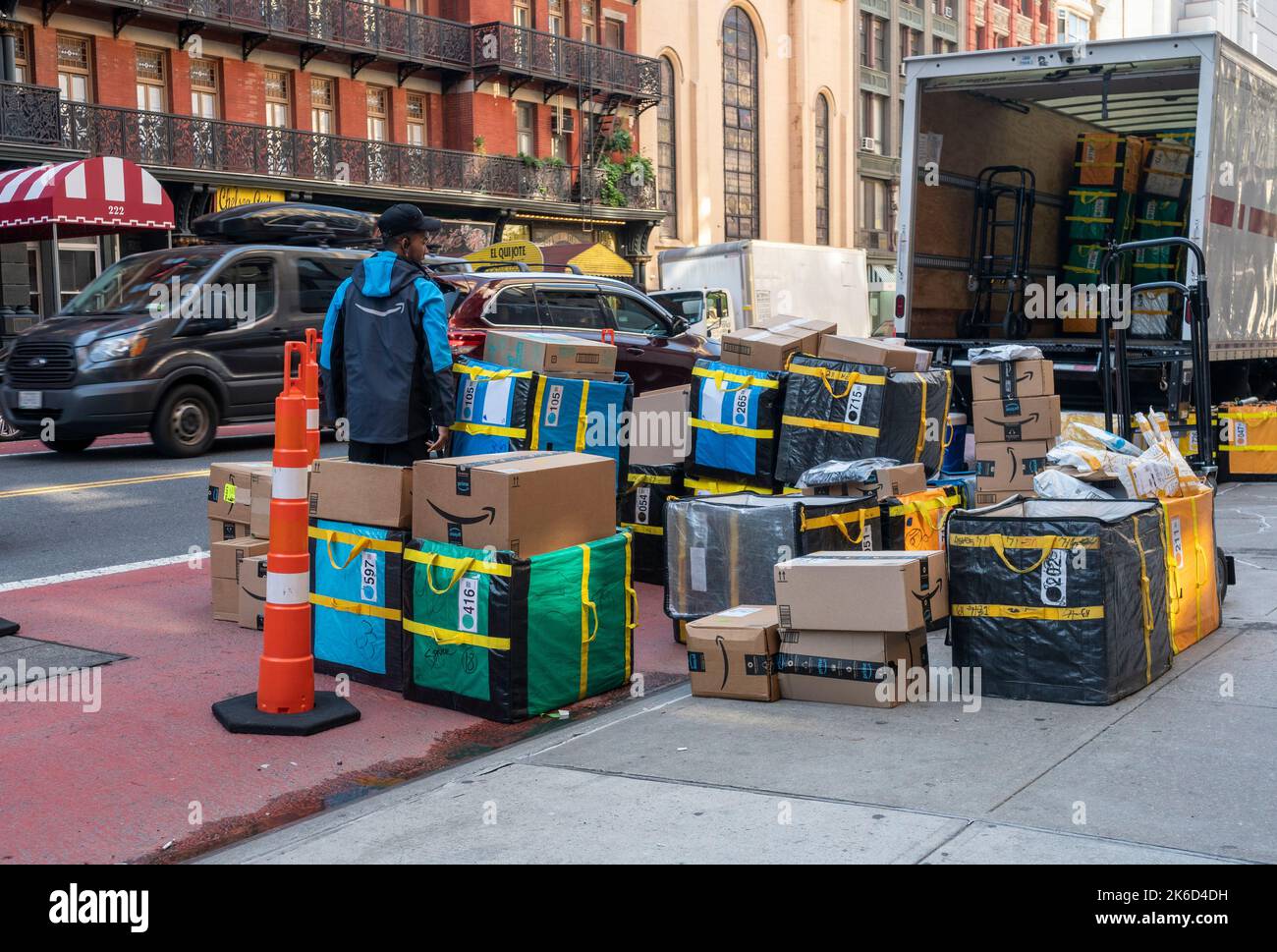 Worker prepares Amazon deliveries for distribution in the Chelsea ...