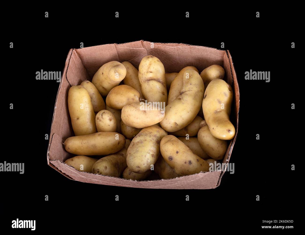 Ratte potato in front of black background Stock Photo - Alamy