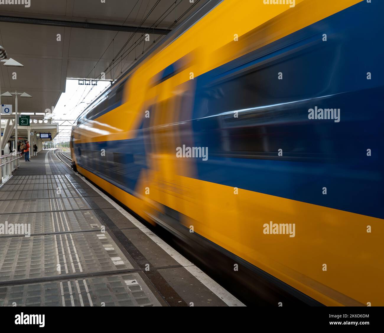 A long exposure of a yellow NS (Nederlandse Spoorwegen) train at the station of Leiden Stock ...