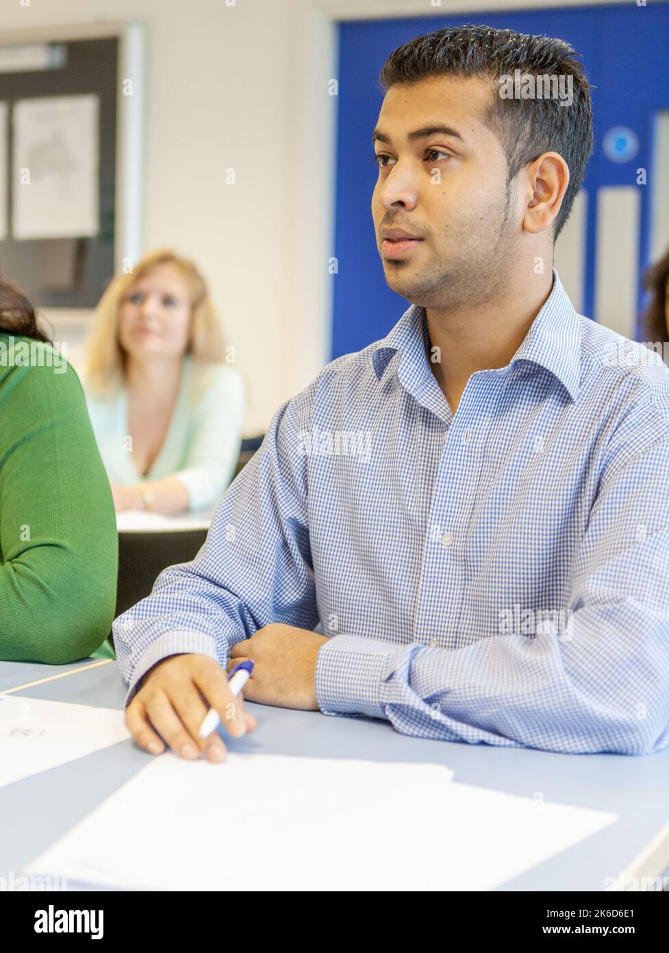 Adult Education: Attentive Learner. A mature student listening to his ...