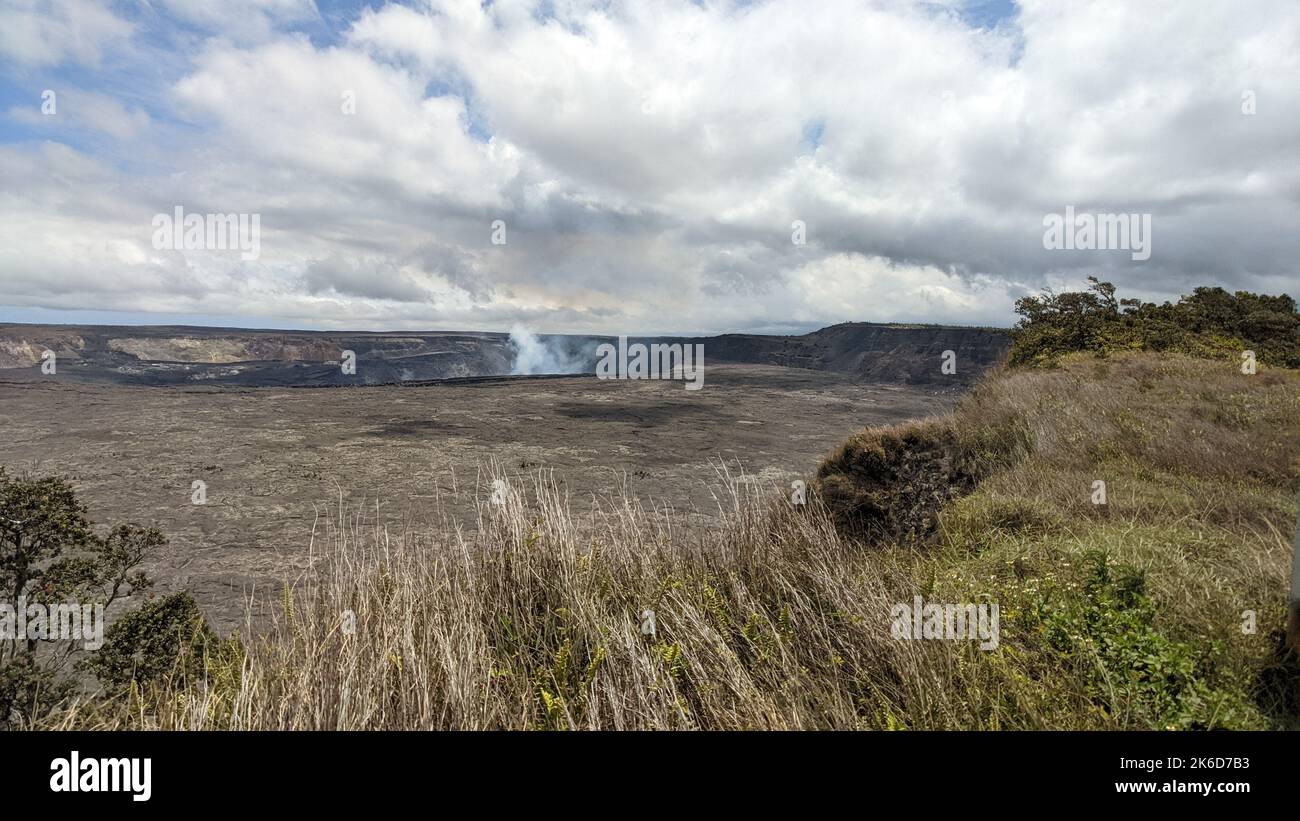 A beautiful landscape of a field under a cloudy sky Stock Photo - Alamy