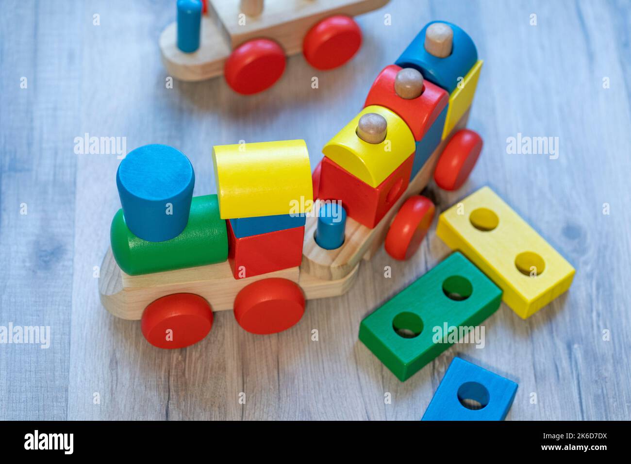 Wooden toy train with colorful blocks on gray wooden floor Stock Photo ...