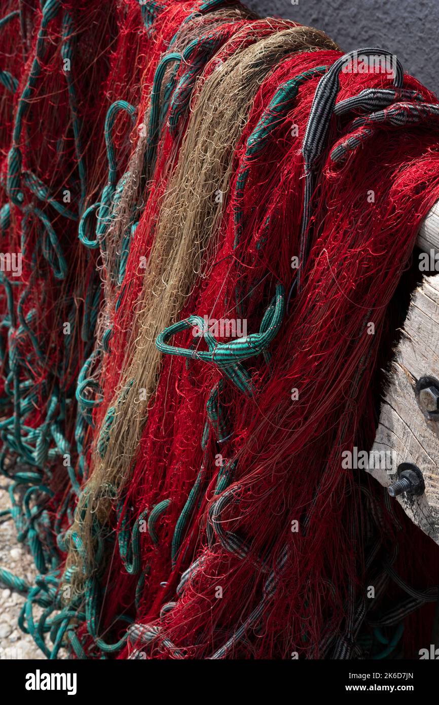 red fishing nets hanging to dry Stock Photo - Alamy