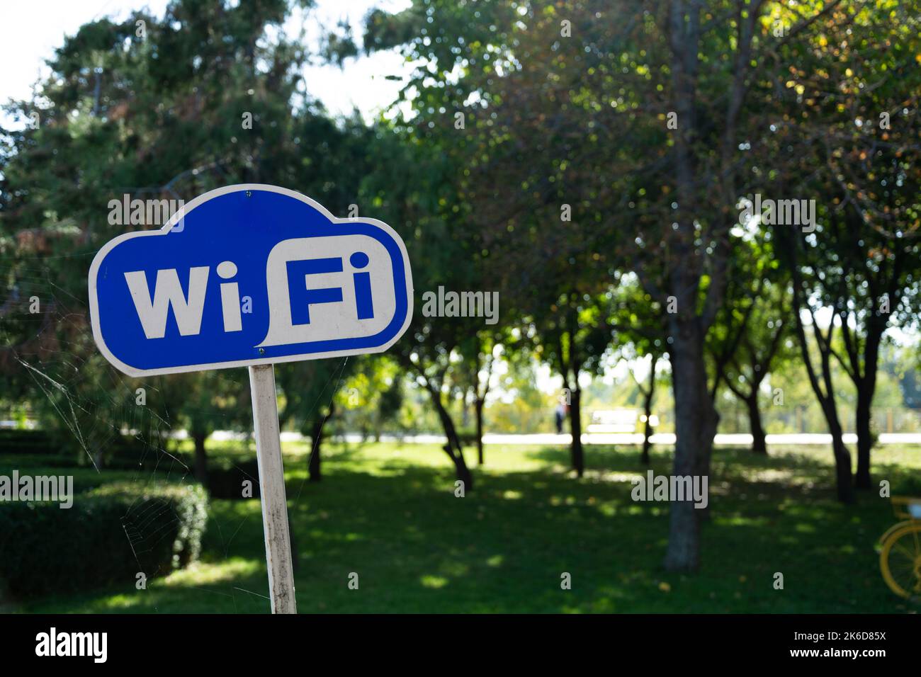 Wifi sign. Blue and white wifi sign board on the green background in ...