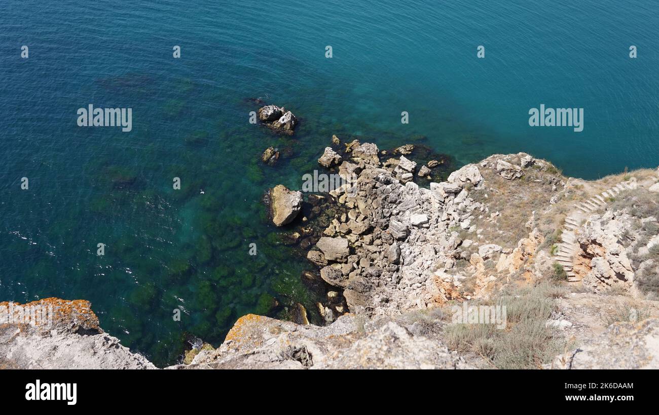 An aerial view of the azure sea by the rocky cliff Stock Photo - Alamy
