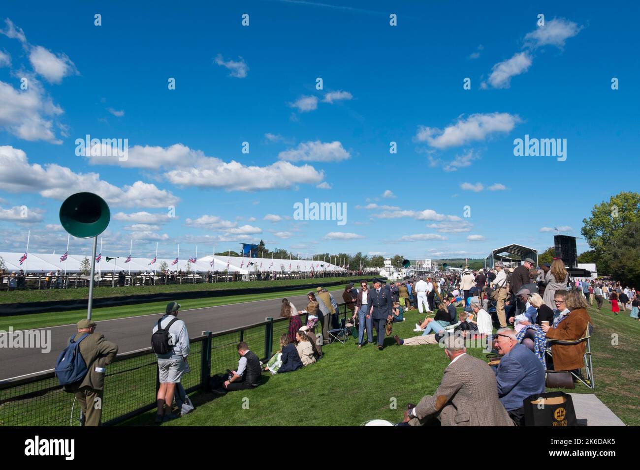 People in period dress on the grassy bank spectator area along the ...
