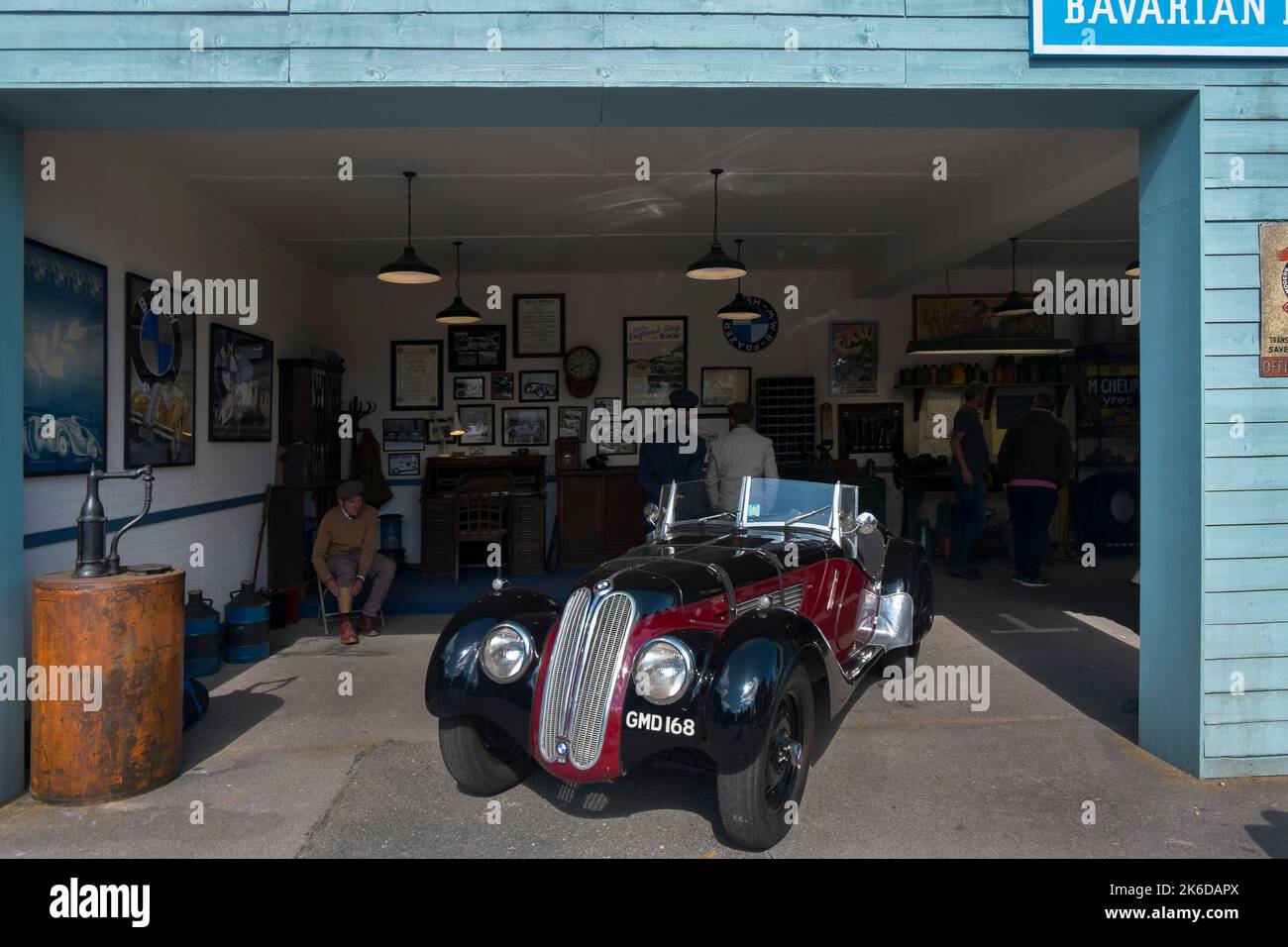 People dressed in vintage period clothes looking at Frazer Nash BMW ...