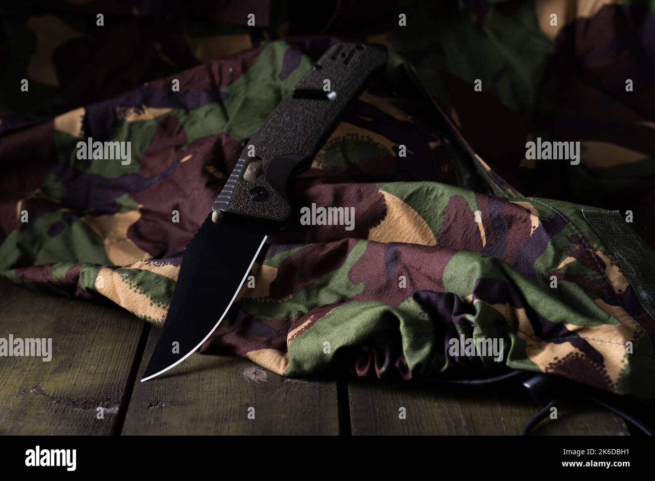 Army knife with black blade. Knife and army uniform. Camouflage and ...