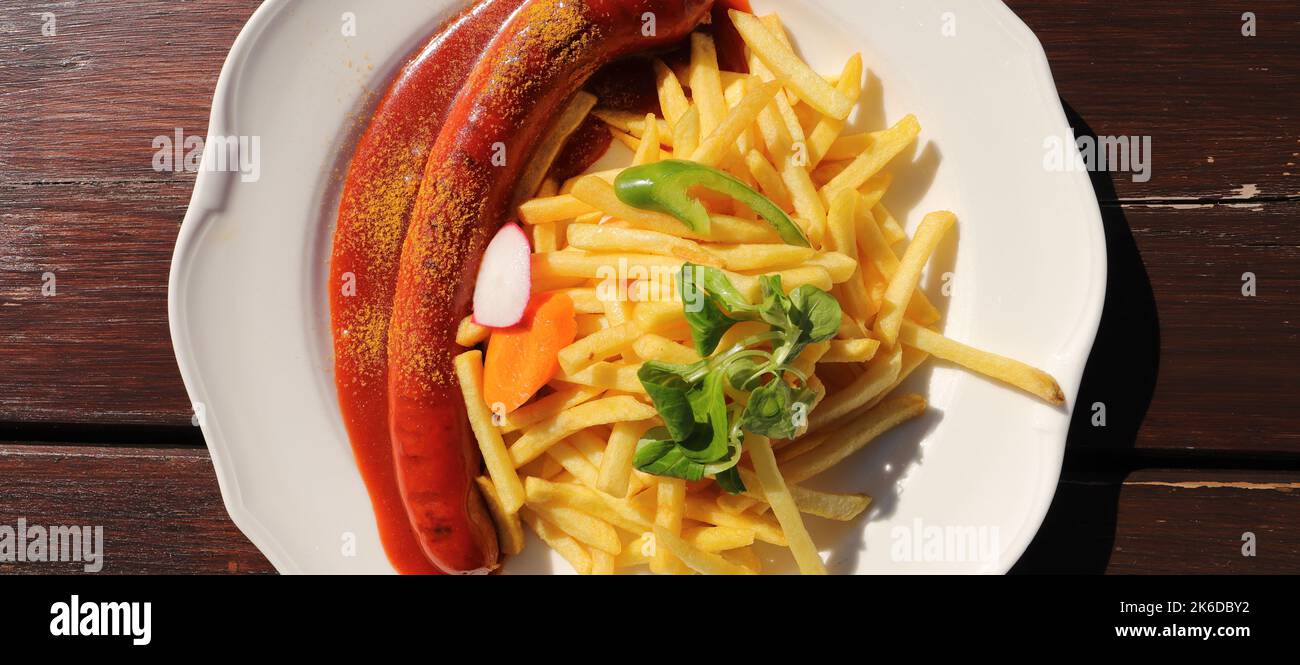 delicious sausage with french fries and curry sauce Stock Photo - Alamy