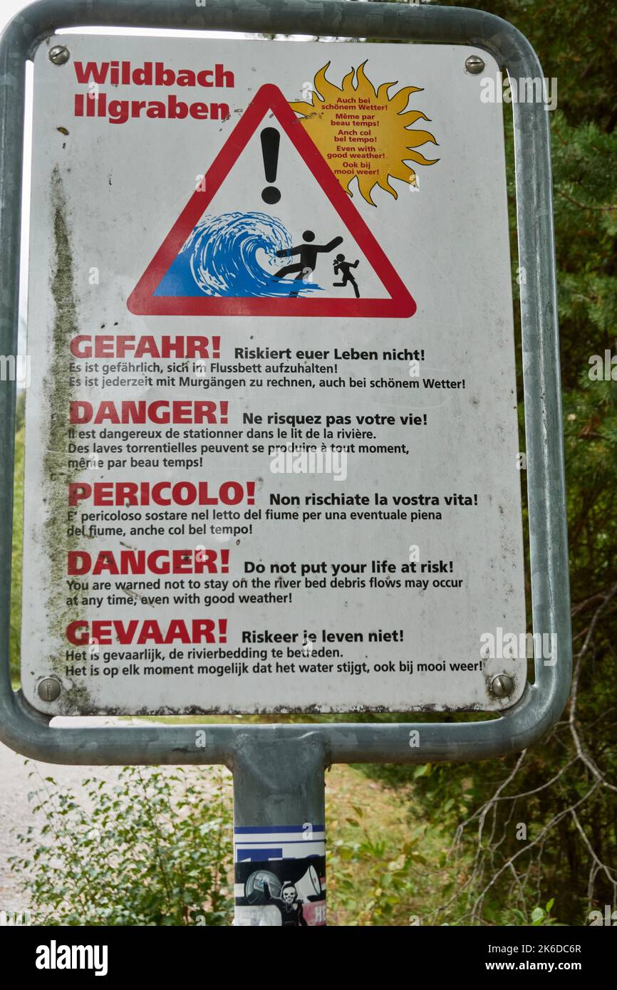 A warning flood sign saying "do not put your life at risk" in different ...