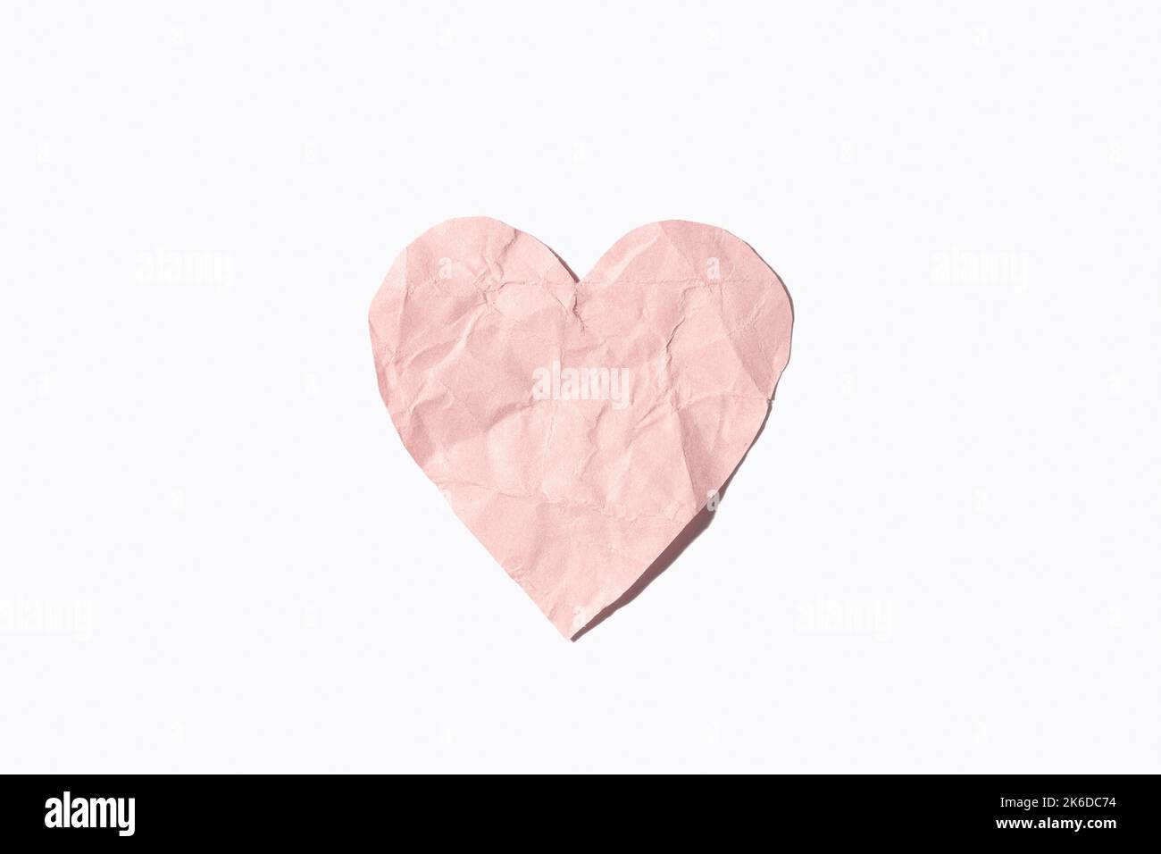 Pink crumpled paper heart isolated on white background Stock Photo - Alamy