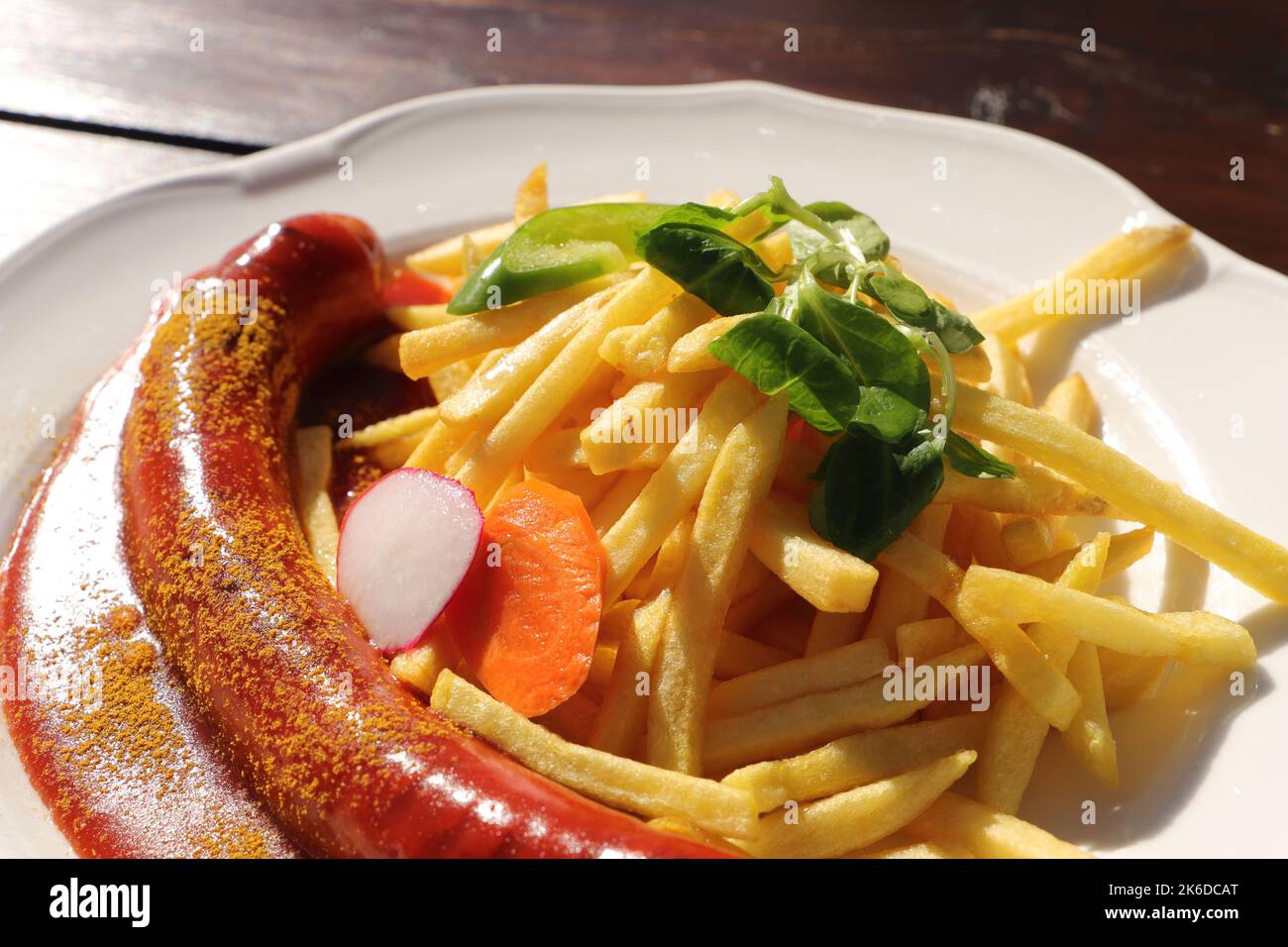 delicious sausage with french fries and curry sauce Stock Photo - Alamy