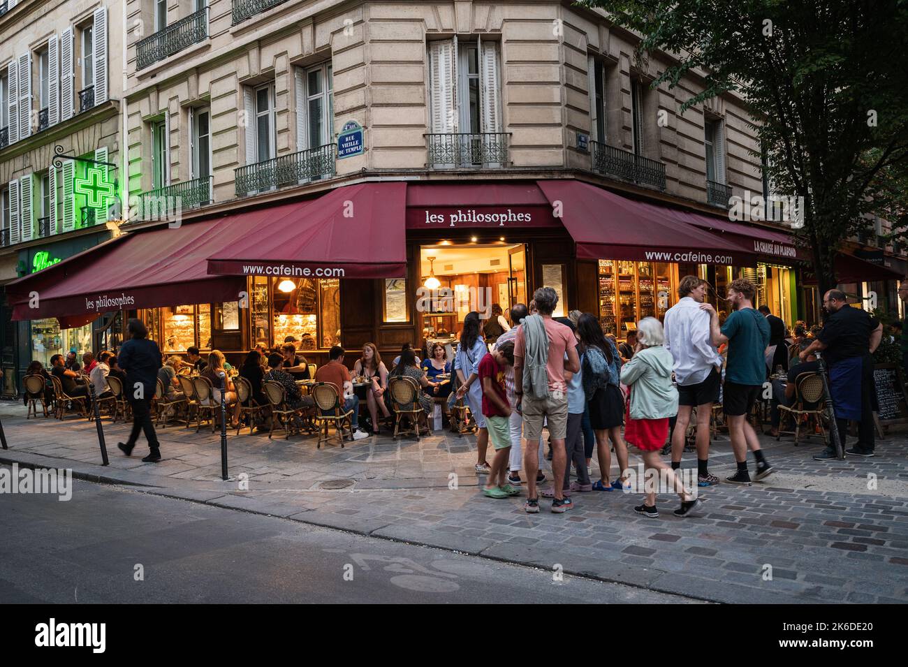 Paris, France - August 27 2022: People walking and dining in cafe in ...