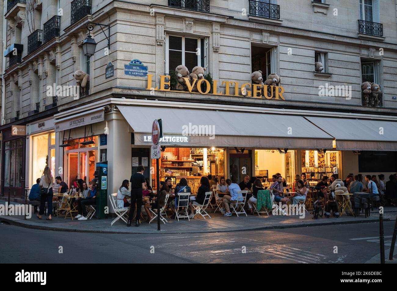 Paris, France - August 27 2022: People walking and dining in cafe in ...