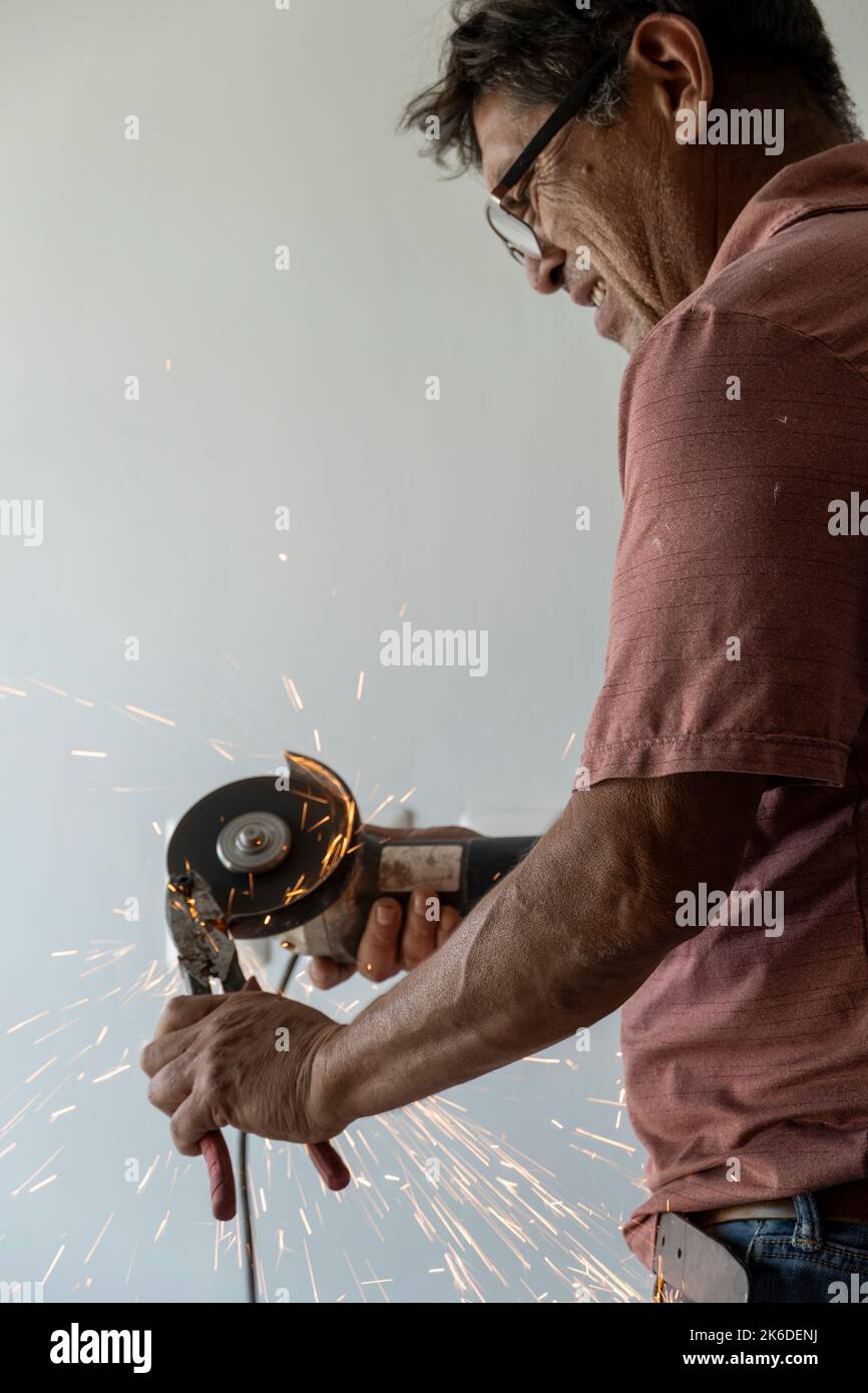 Latin worker using angle grinder hi-res stock photography and images ...