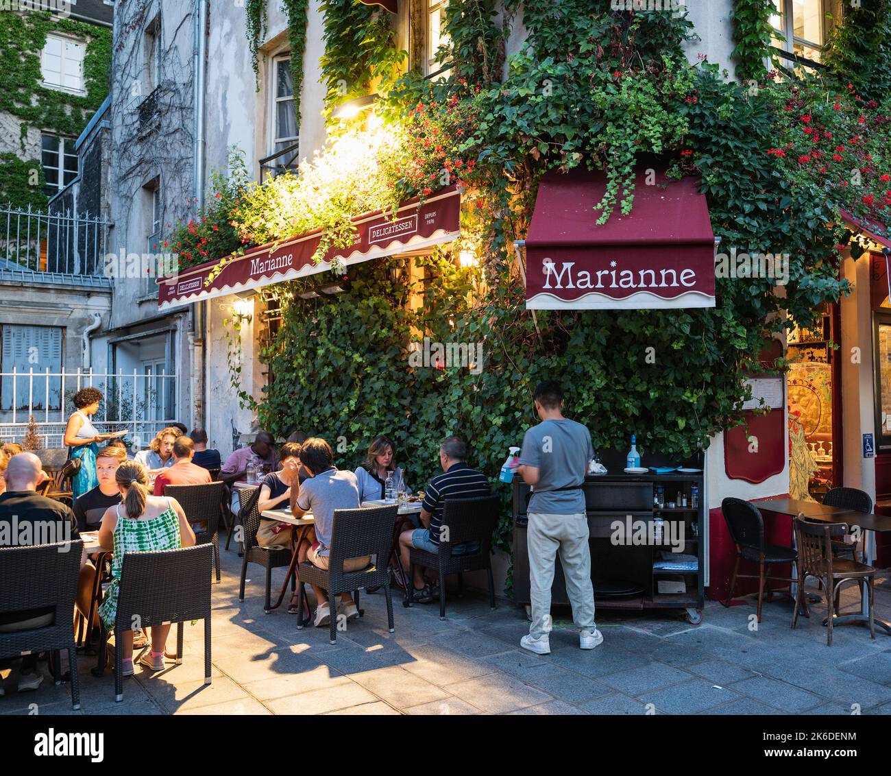Paris, France - August 27 2022: People walking and dining in cafe in ...