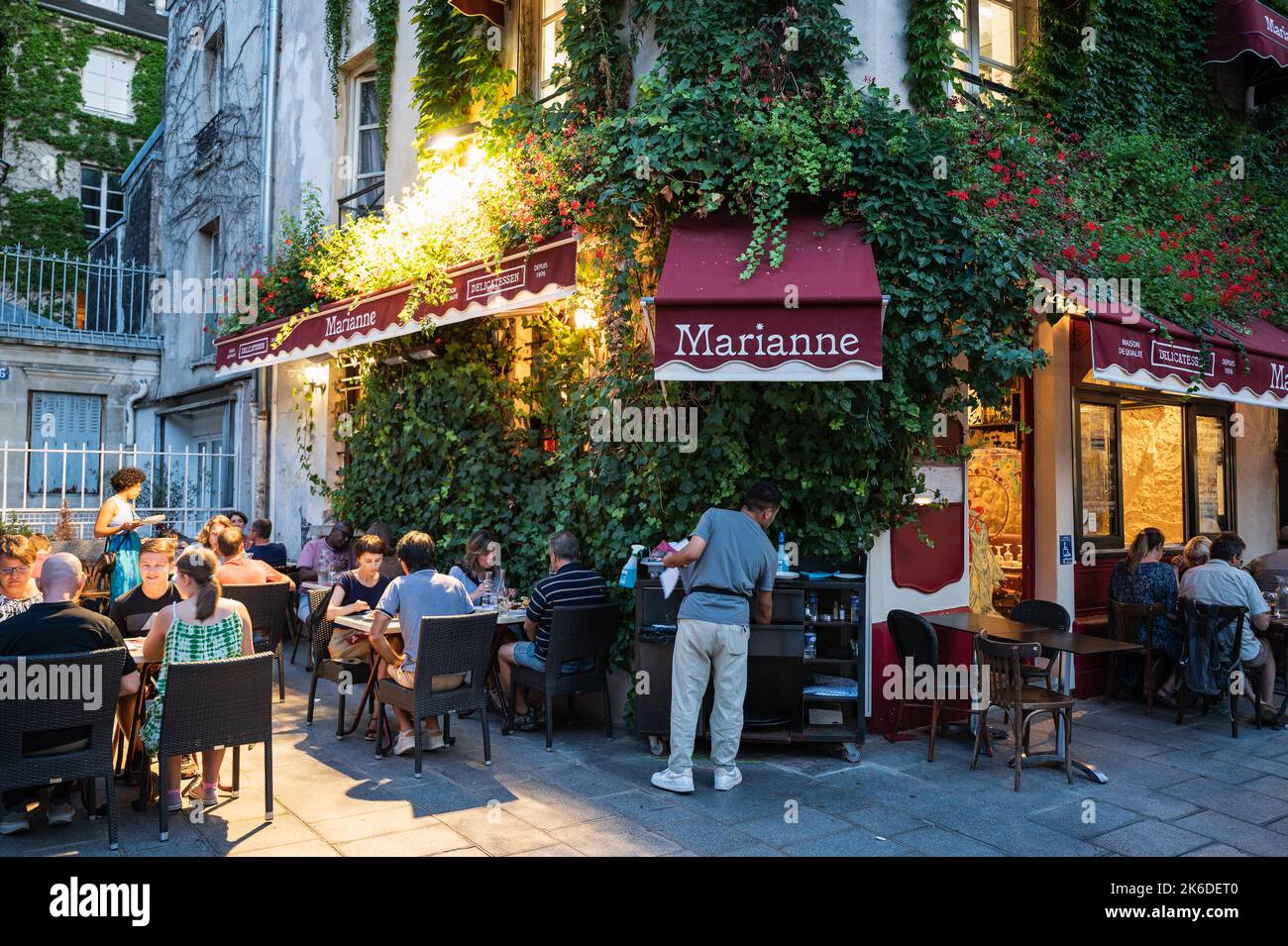 Paris, France - August 27 2022: People walking and dining in cafe in ...