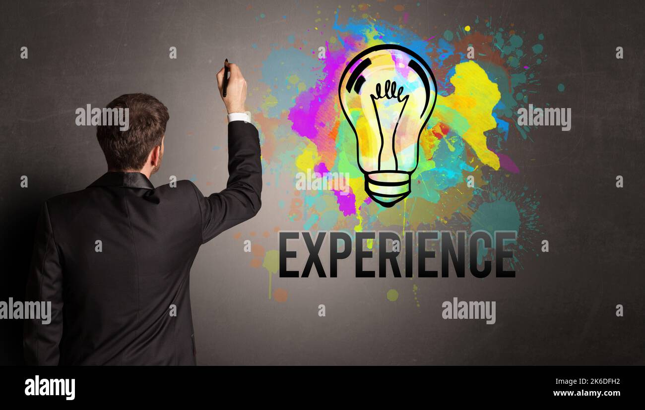 businessman drawing colorful light bulb Stock Photo - Alamy