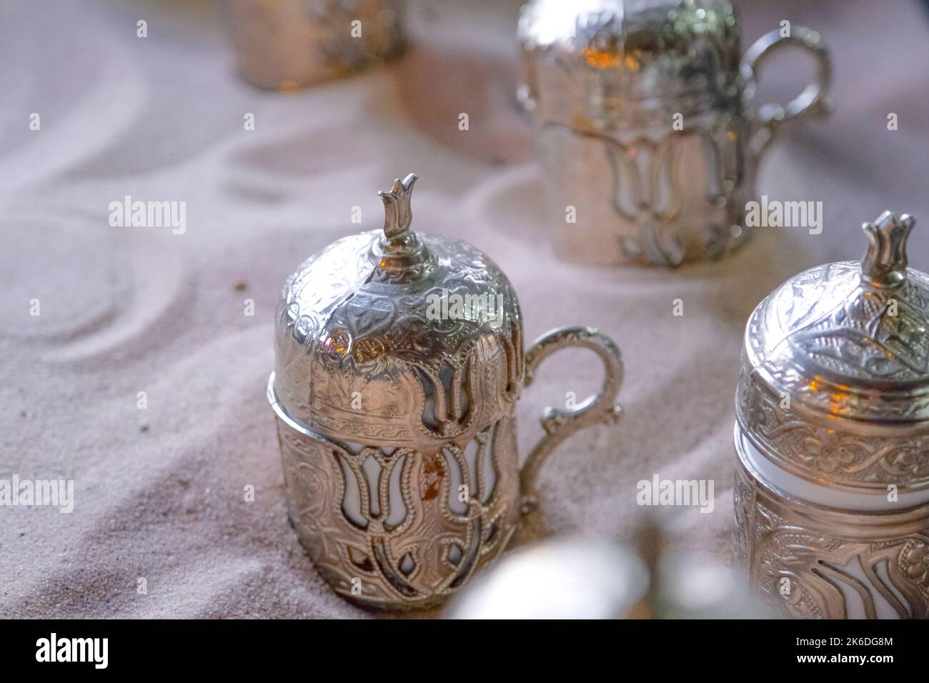 Copper cups with Turkish coffee cooked in hot sand Stock Photo - Alamy