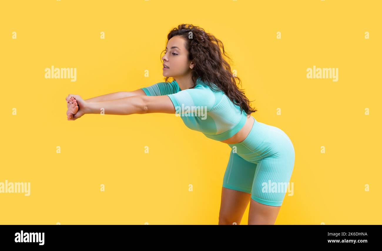 Athletic girl doing forward bending studio. Active girl exercising ...