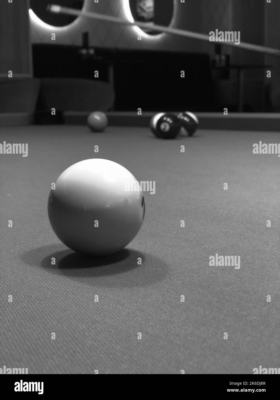 A grayscale shot of a white pool ball on the table Stock Photo - Alamy