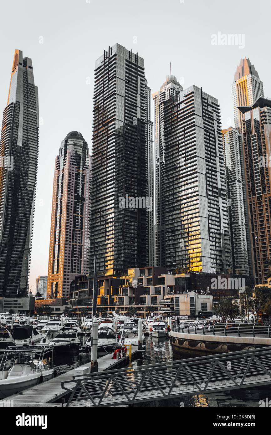 A vertical shot of buildings in Marina Bay with a sunset sky background ...