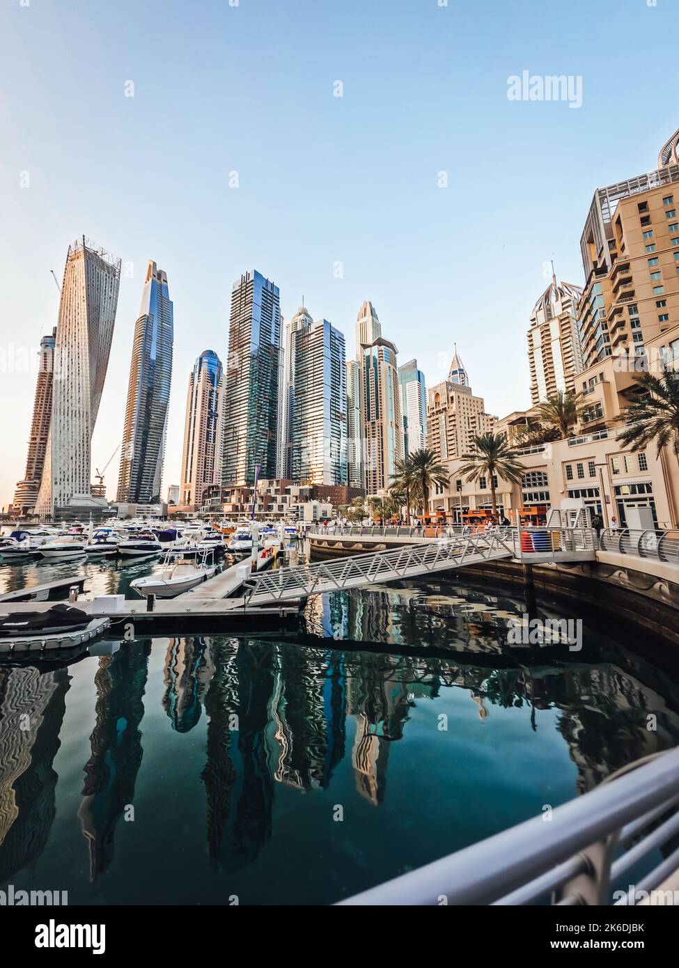 A vertical shot of buildings in Marina Bay with a blue sky background ...