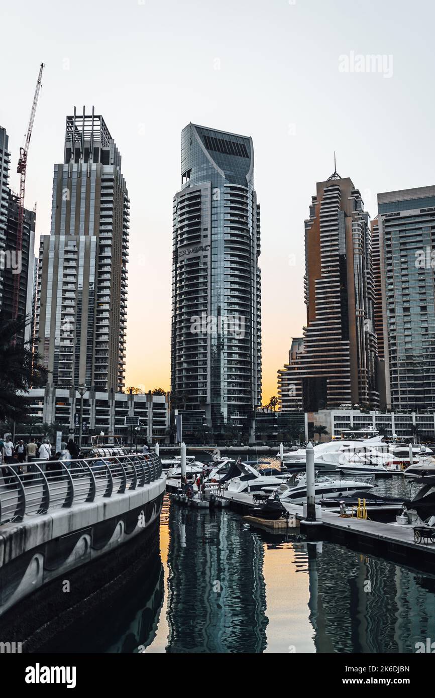 A vertical shot of buildings in Marina Bay with a sunset sky background ...