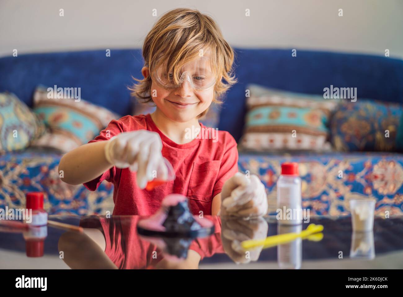 Kid boy doing chemical experiment at home. Child with protective ...