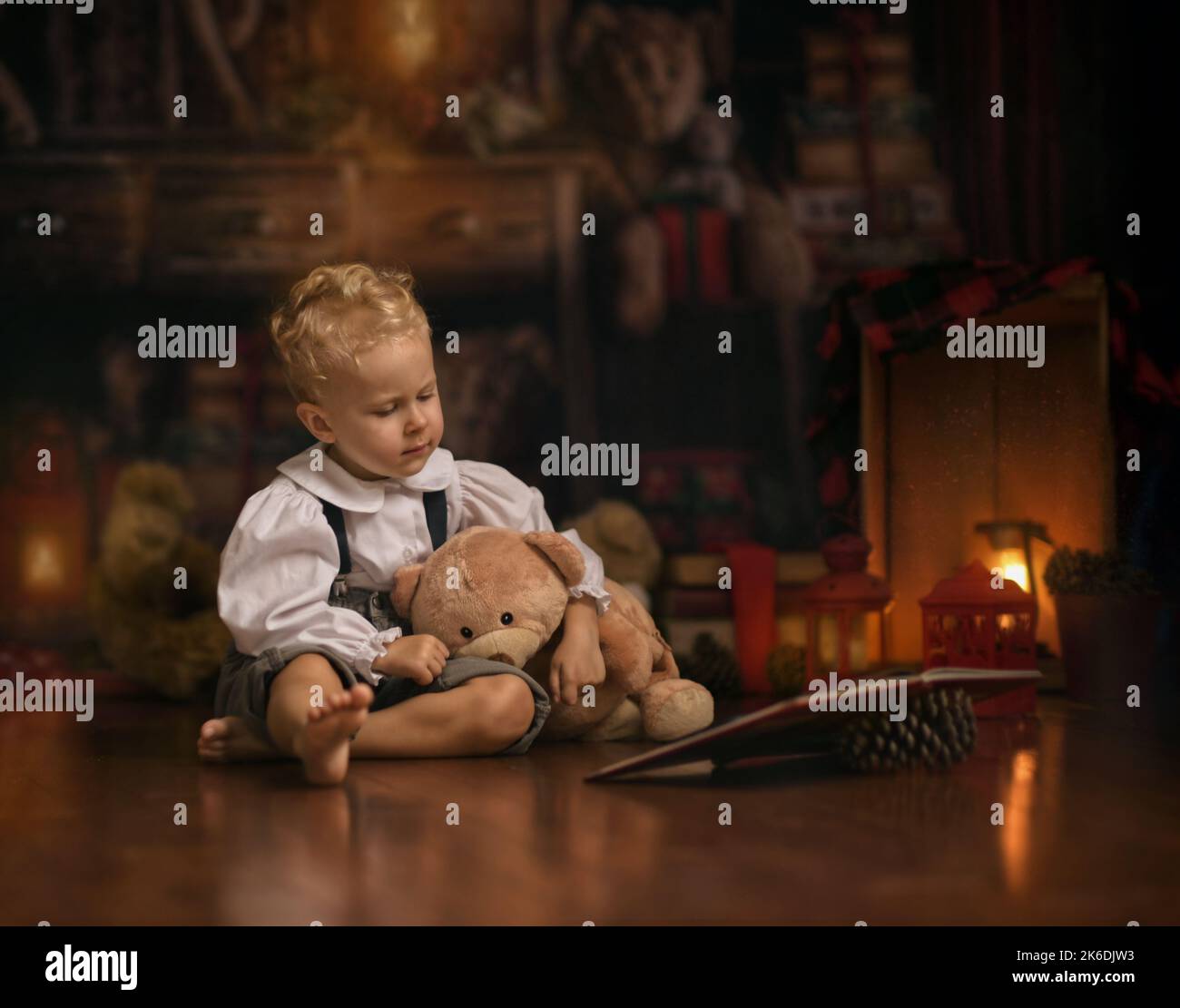 little boy with teddy bear reading Christmas book Stock Photo - Alamy