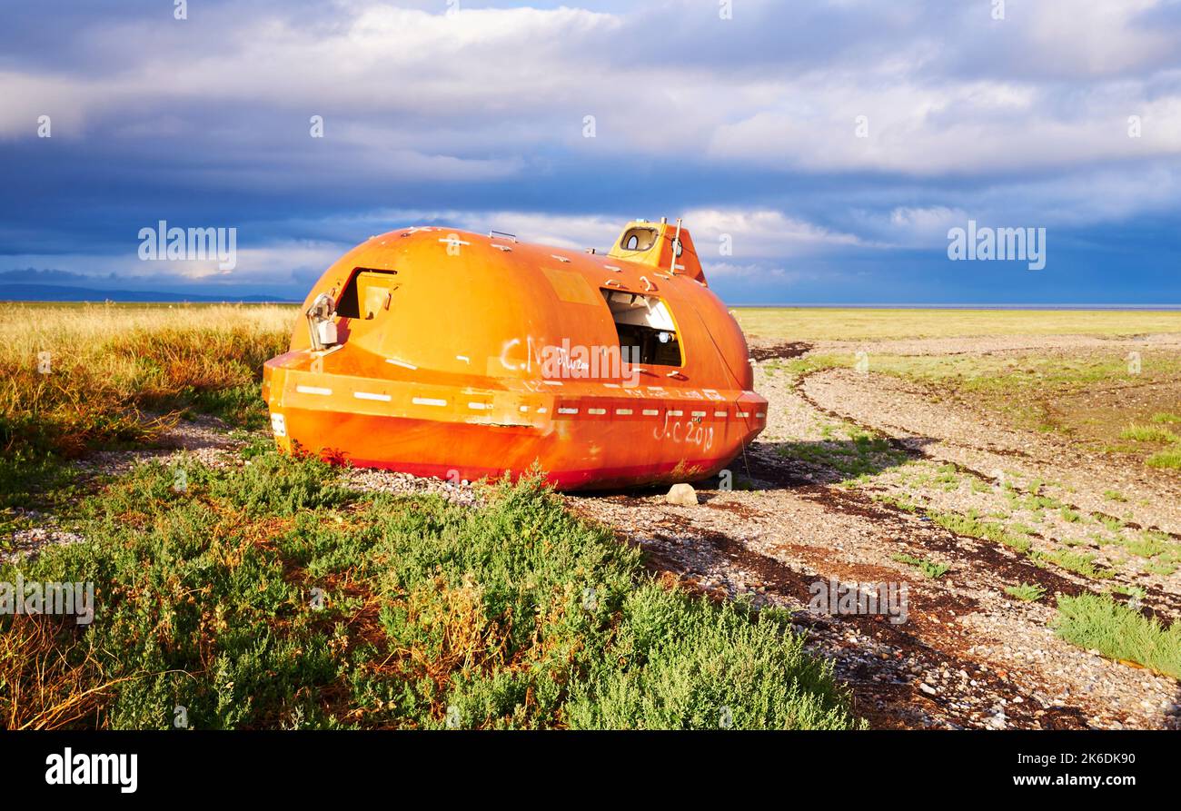 An orange lifeboat near the Roa Island under the clouds Stock Photo - Alamy