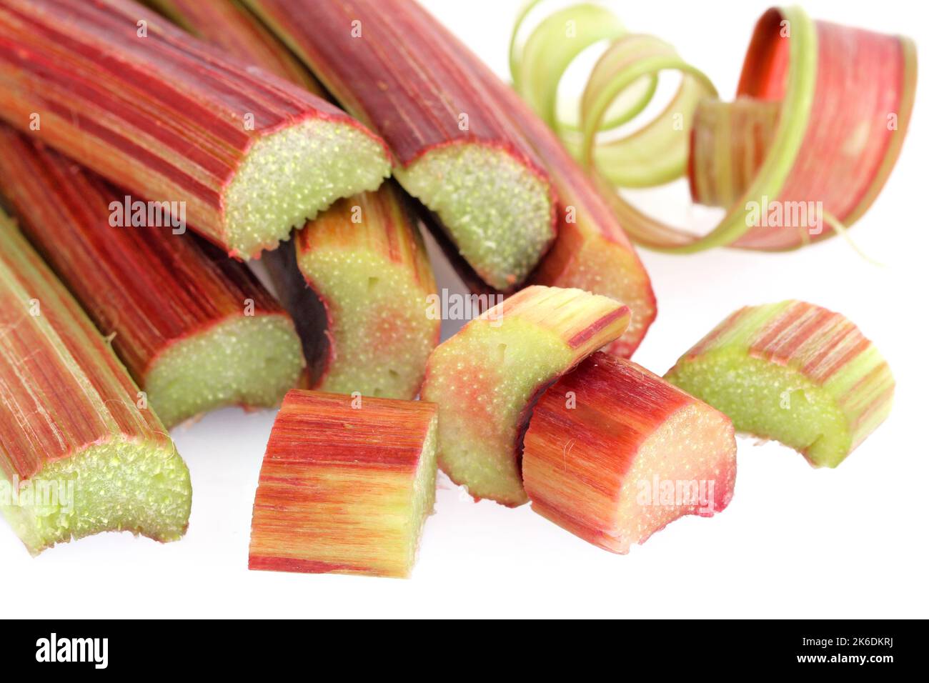 Rhubarb with cut pieces and peeled skin on white background Stock Photo ...