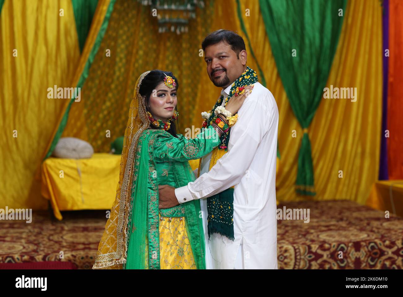 Bride and Groom at Traditional Mayoon ceremony at colorfully decorated ...