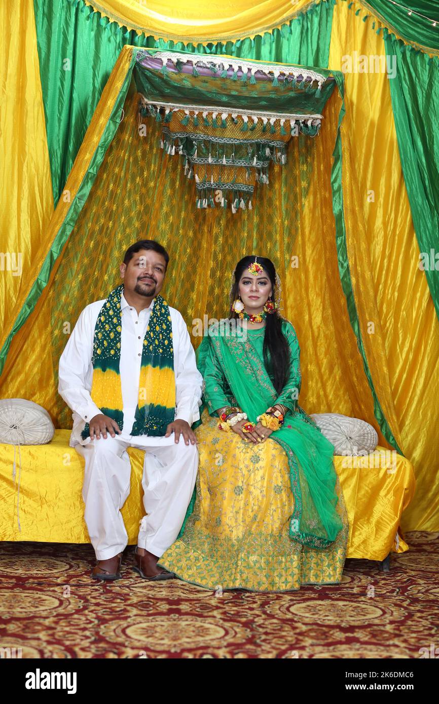 Bride and Groom at Traditional Mayoon ceremony at colorfully decorated ...