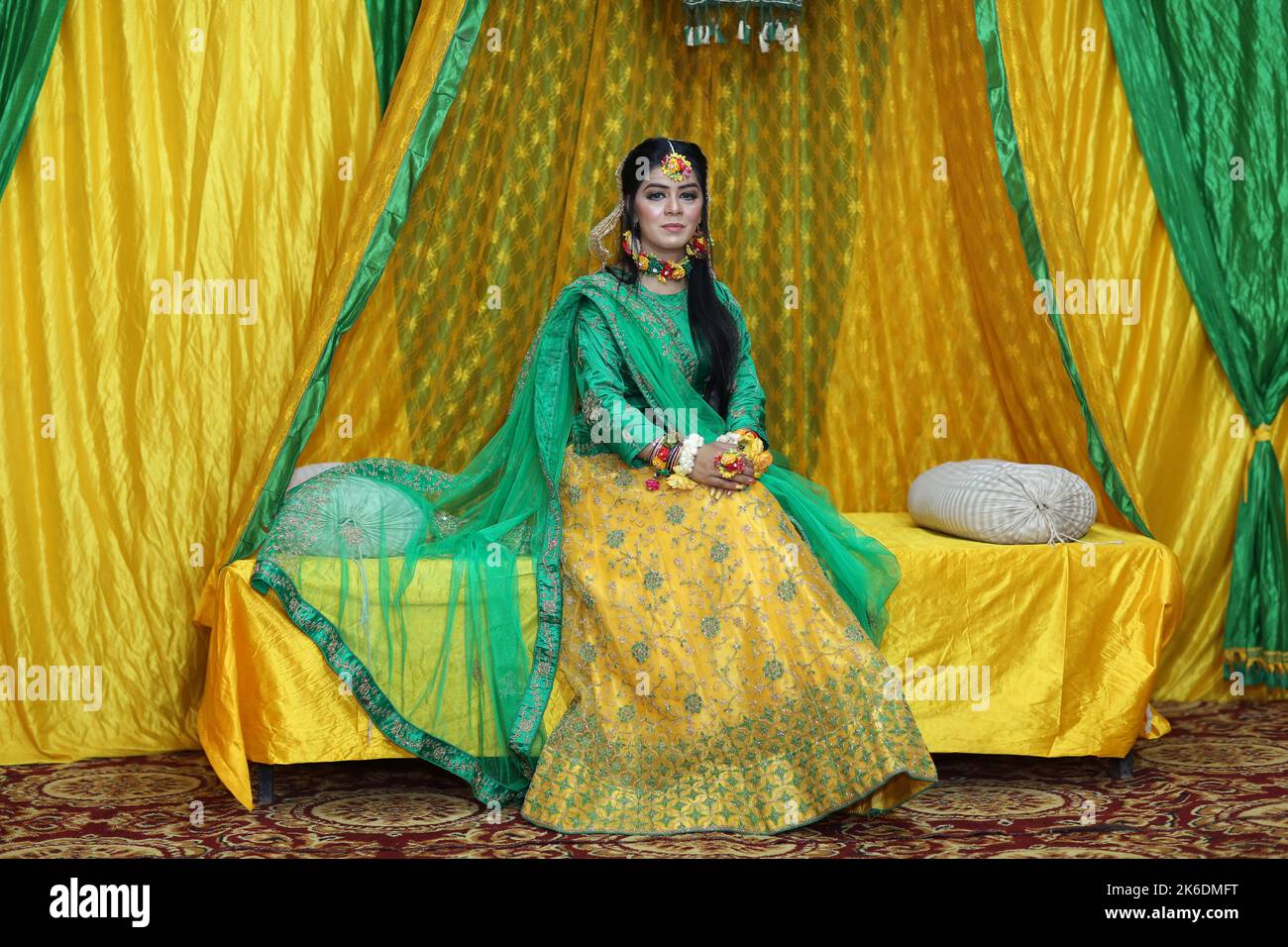 Bride at Traditional Mayoon ceremony at colorfully decorated venue in ...
