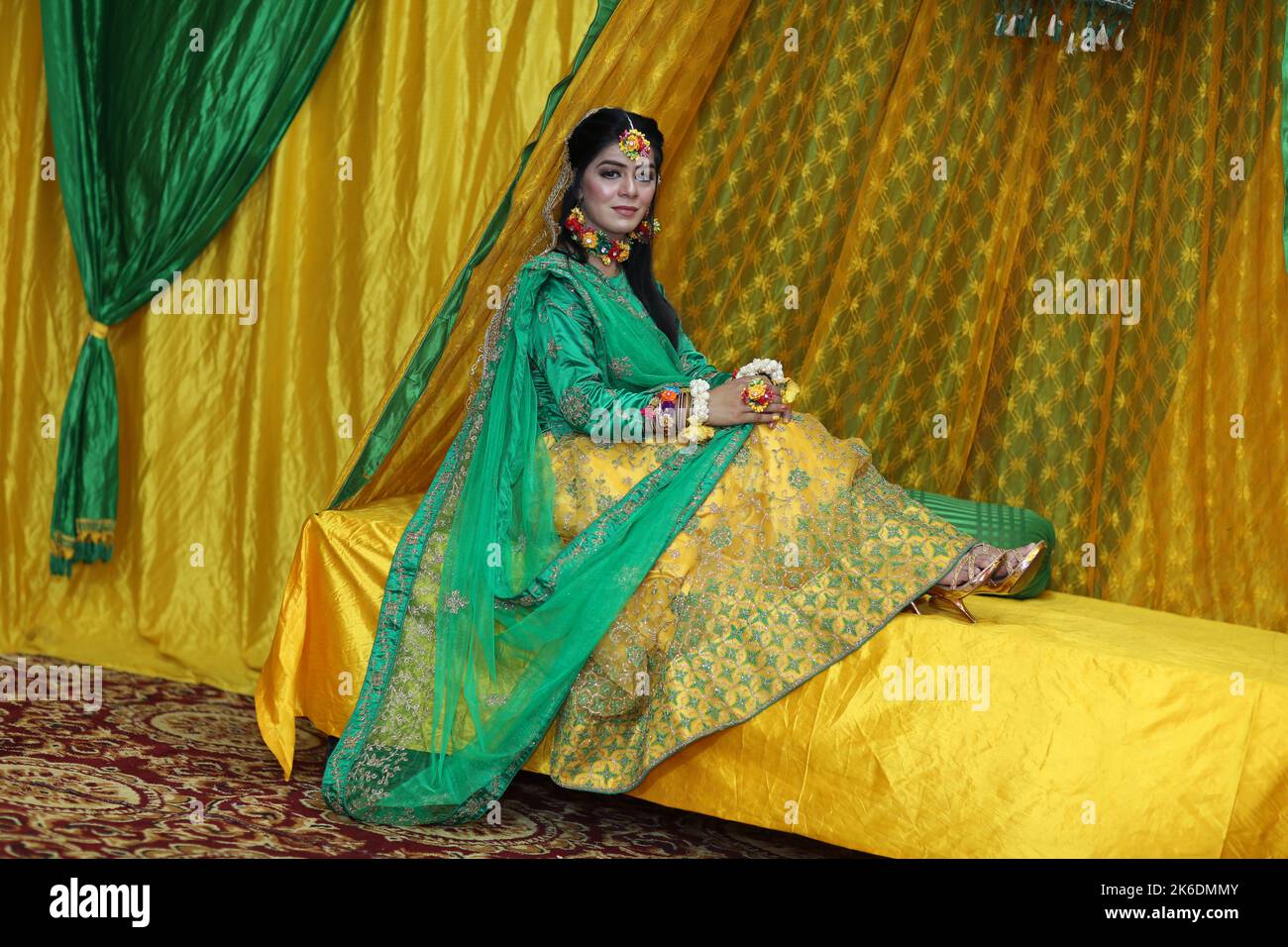 Bride at Traditional Mayoon ceremony at colorfully decorated venue in ...