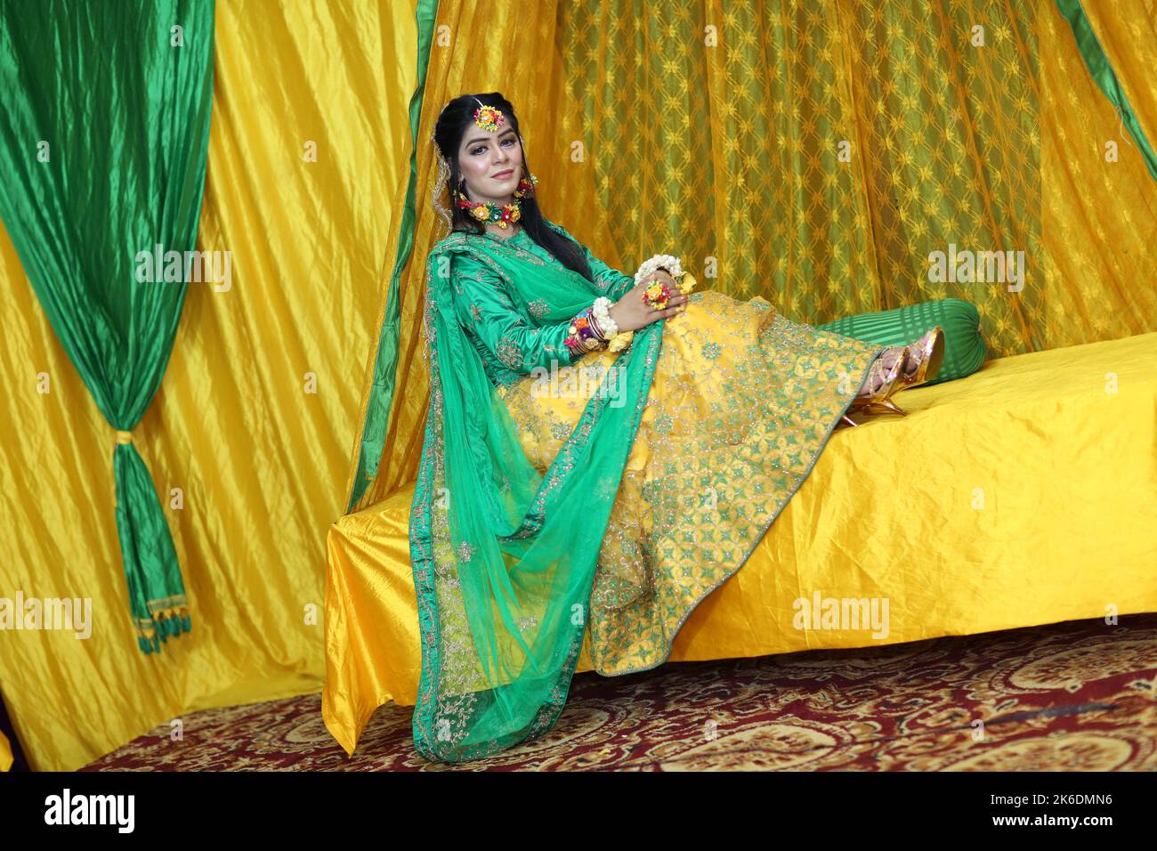 Bride at Traditional Mayoon ceremony at colorfully decorated venue in ...