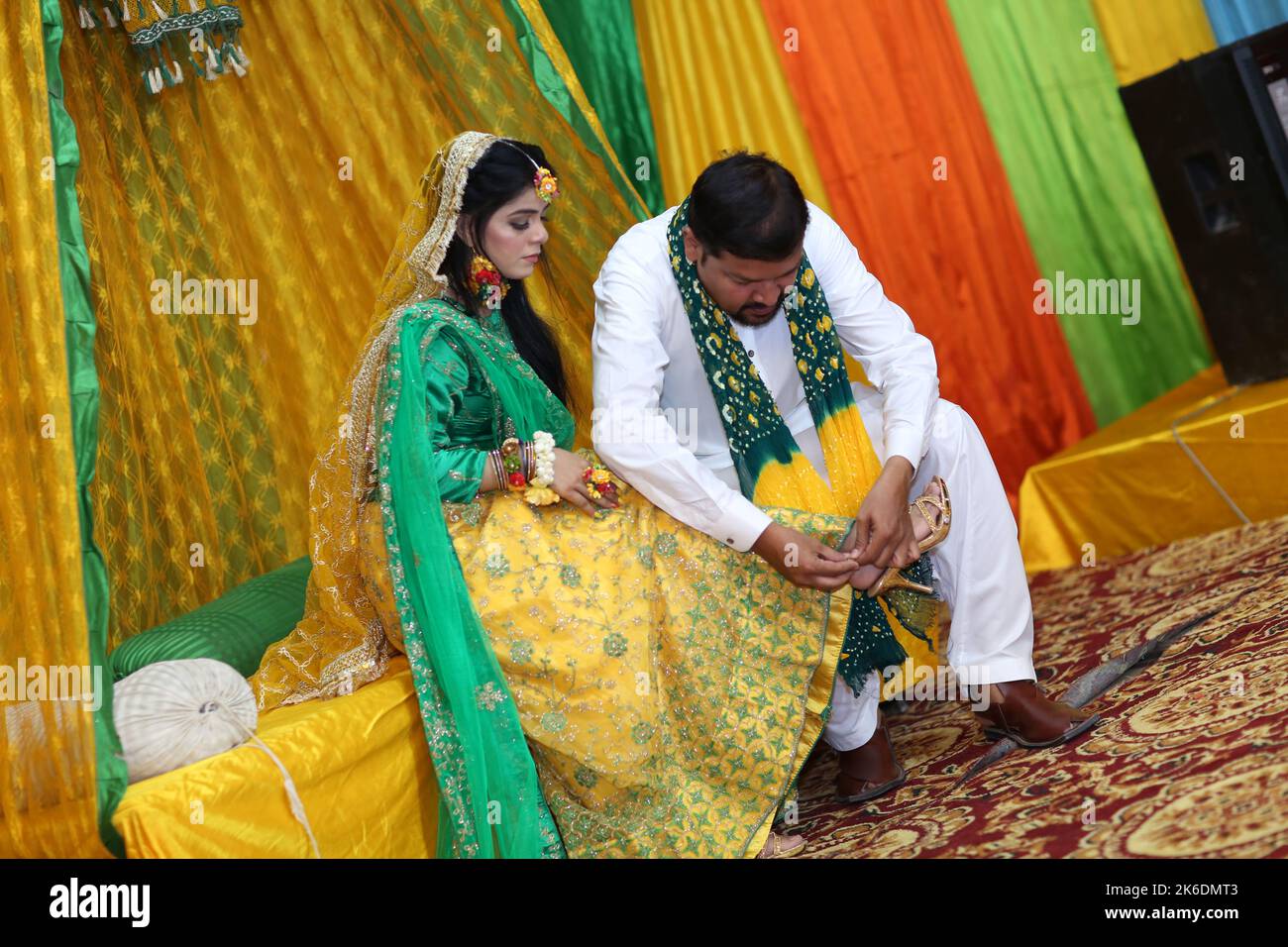 Bride and Groom at Traditional Mayoon ceremony at colorfully decorated ...