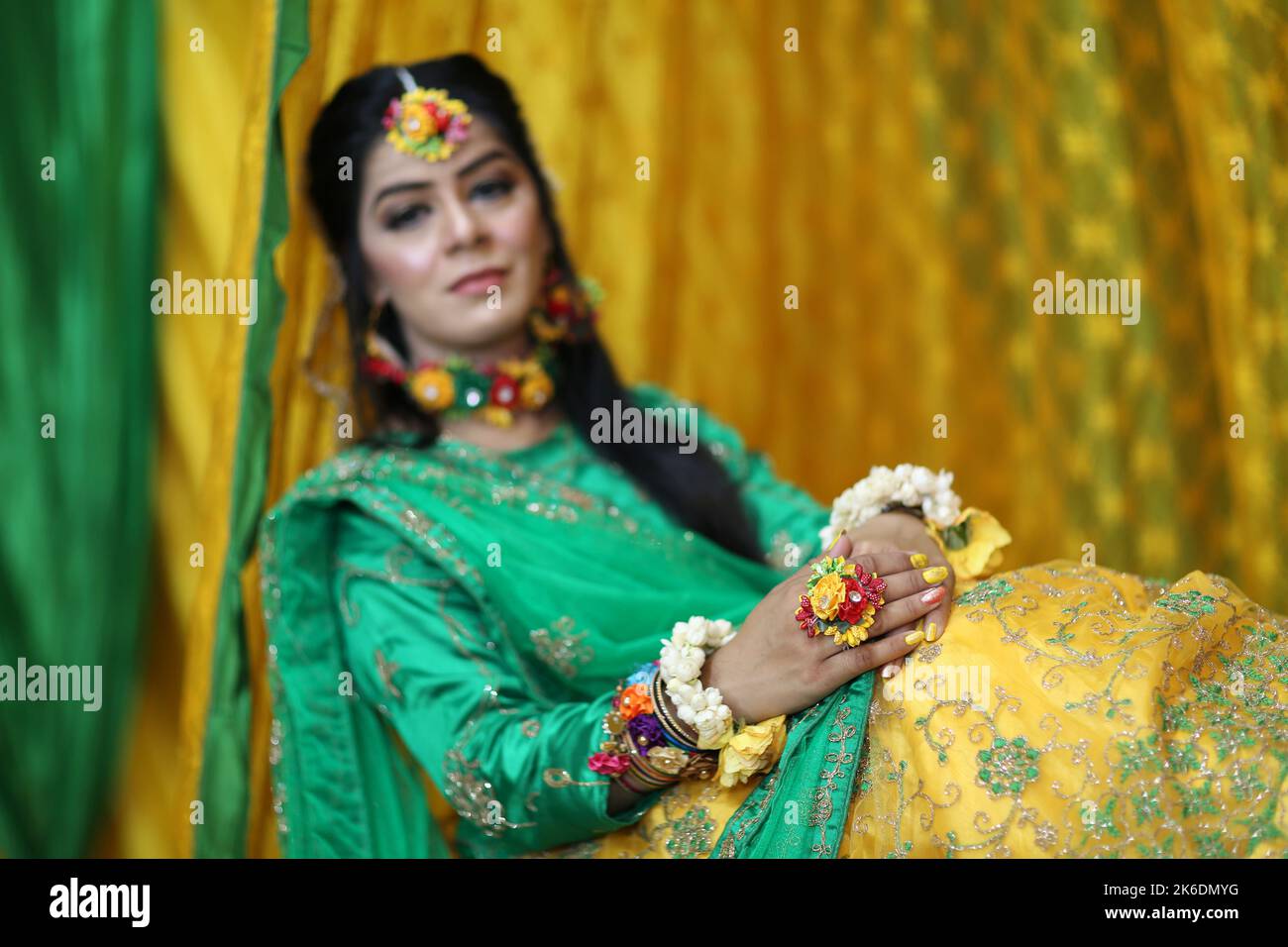 Bride at Traditional Mayoon ceremony at colorfully decorated venue in ...